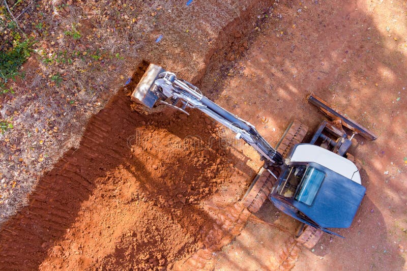 At a Construction Site, Crawler Excavators are Digging the Ground ...