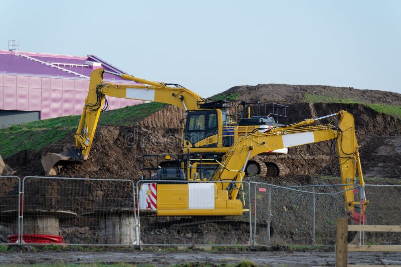 Construction Site Digger Yellow during Excavation on Building Site ...