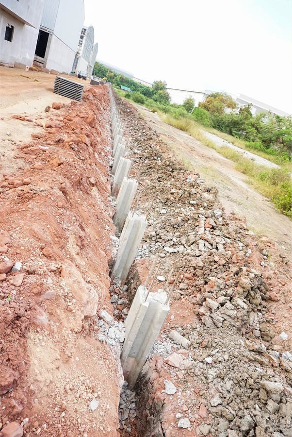 Construction Site : Driven Piles for Fence Around Office Warehouse ...