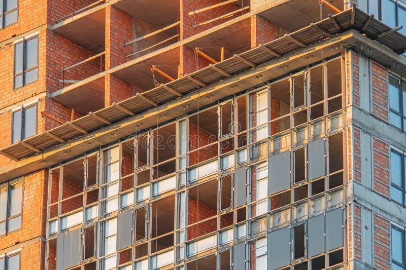 A Construction Site at Dusk Showcases a Tall, Multi-story Building in ...