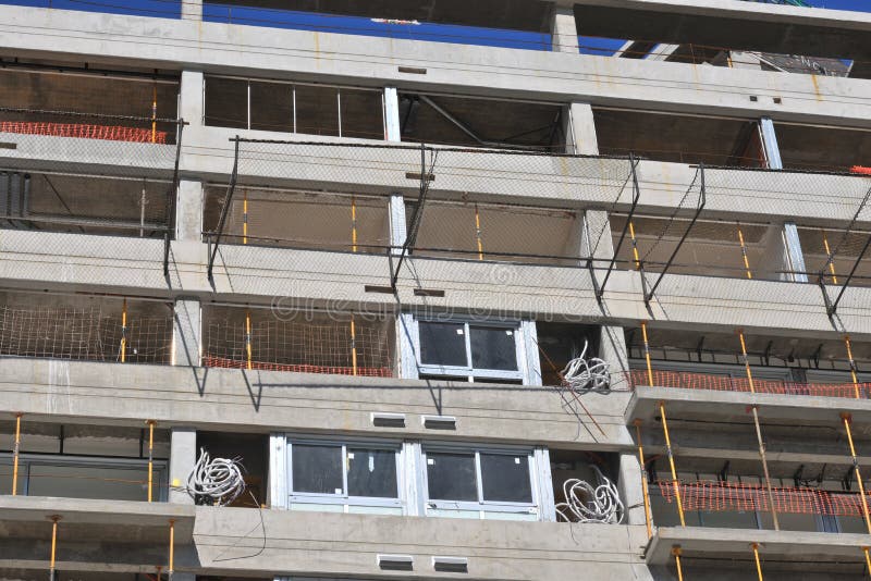 Construction Site at an Early Stage. Finished Houses. Cranes at the ...