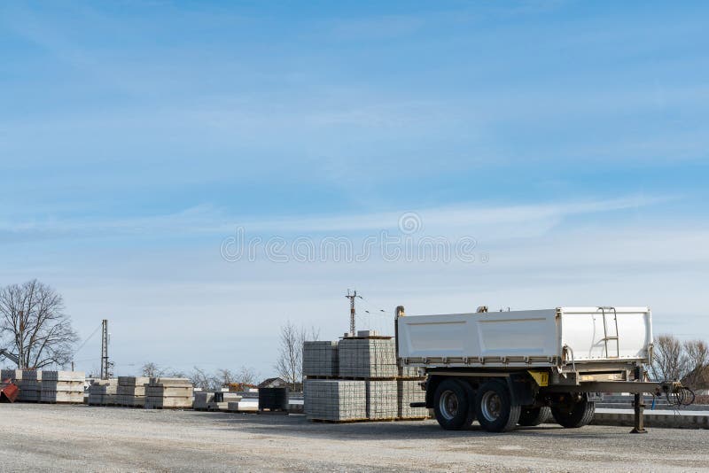Construction Site with Empty Car Trailer and Building Materials . Stock ...