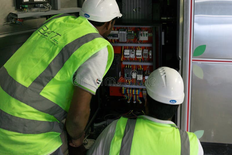 Construction Site with Engineers and Workers Fixing a Machine in a ...