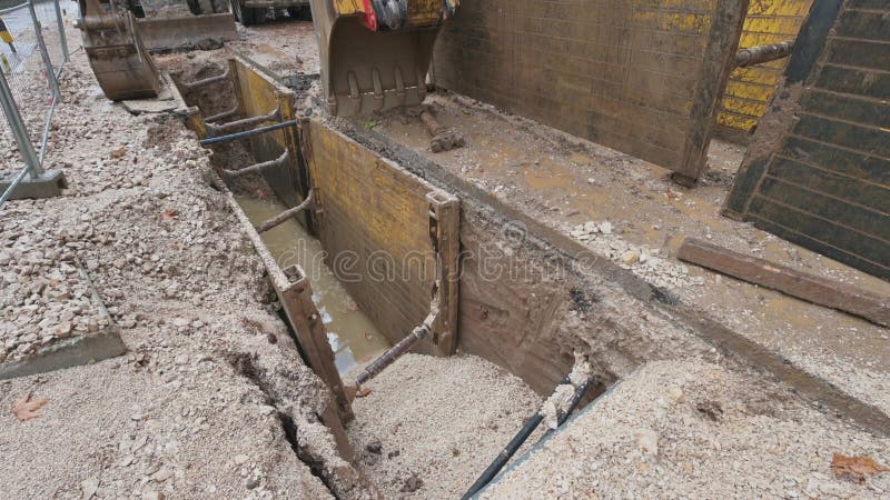 Construction Site with Excavator Digging Deep Trench for Infrastructure ...