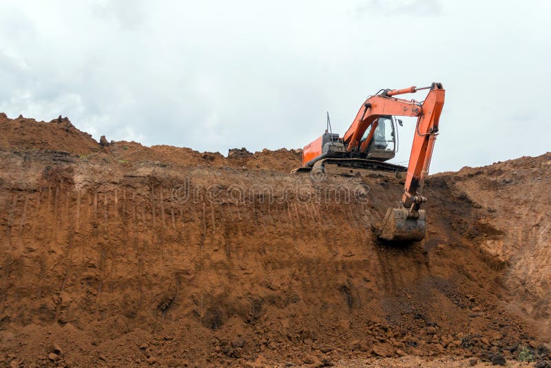 The Construction Site Excavator Digs a Deep Pit. Stock Image - Image of ...