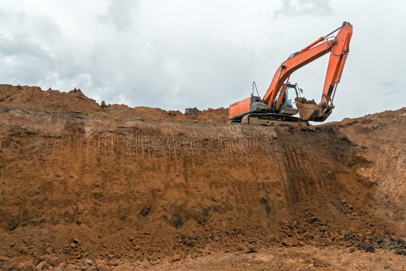 The Construction Site Excavator Digs a Deep Pit. Stock Image - Image of ...