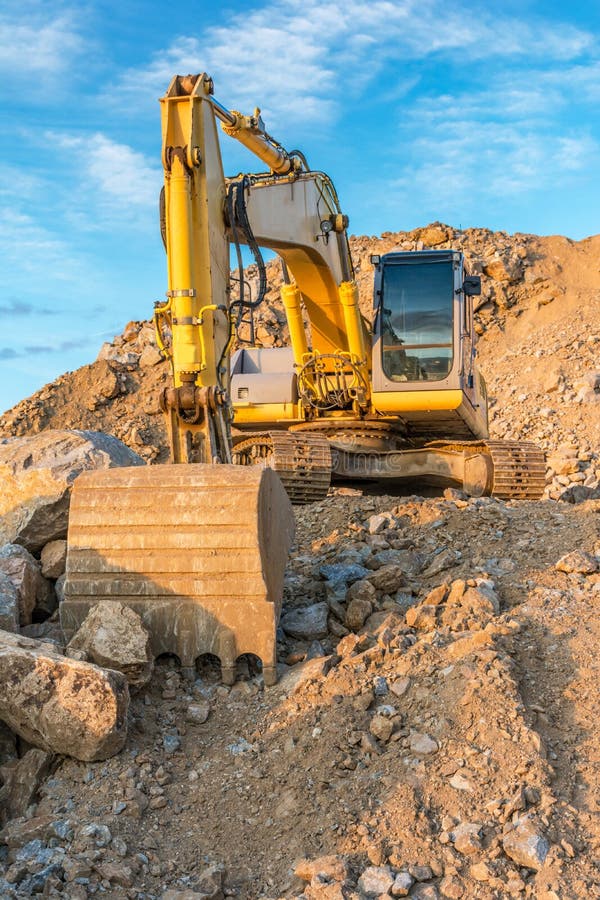 Construction Site with an Excavator Moving Rock Stock Image - Image of ...