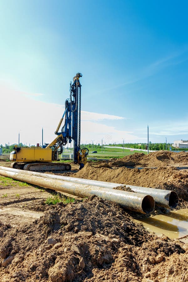Construction Site with Excavator and Pipes in Action Stock Photo ...