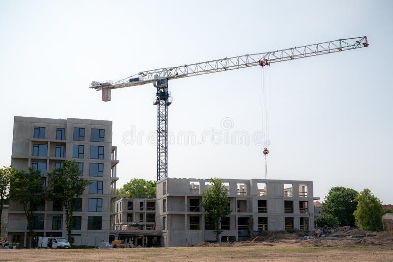 A Construction Site Features a Large Tower Crane with a Long Horizontal ...