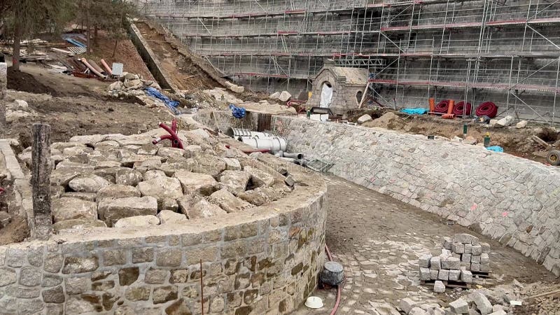 The Construction Site Features Scaffolding and Ongoing Excavation Work ...