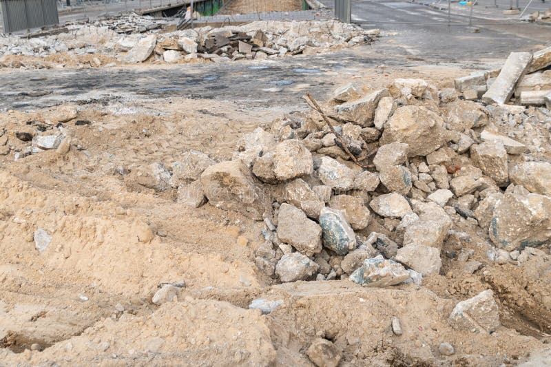A Construction Site Featuring a Pile of Rubble and Sand, with Broken ...
