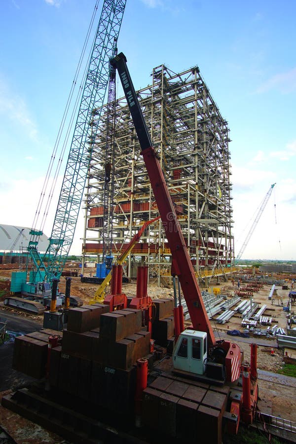 Construction Site Featuring a Tall Steel Framework and Heavy Machinery ...