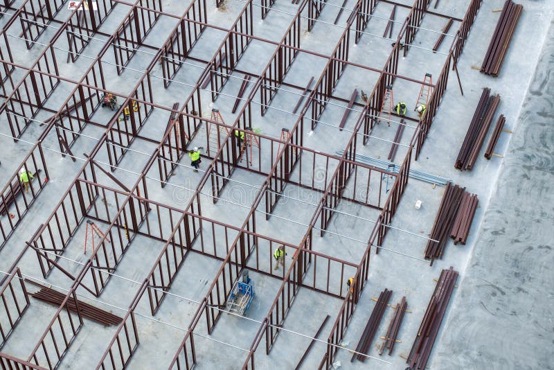 Construction Site with Hardhat Workers Assembling Metal Frame Walls ...