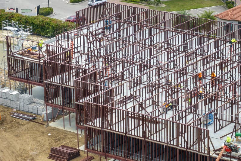 Construction Site with Hardhat Workers Assembling Metal Frame Walls ...
