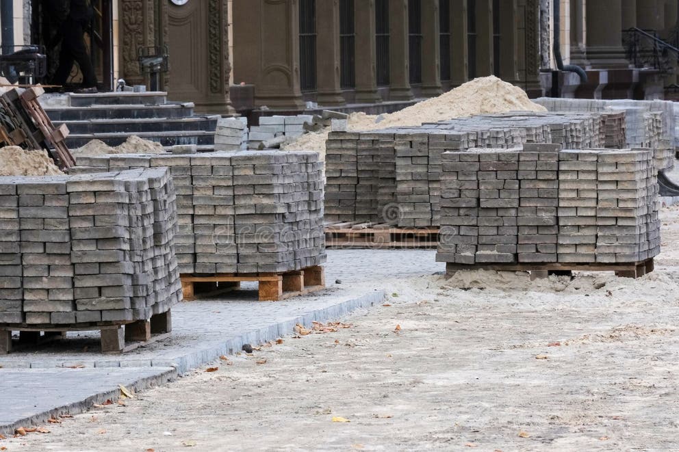 At a Construction Site, There are Many Pallets of Neatly Stacked Paving ...