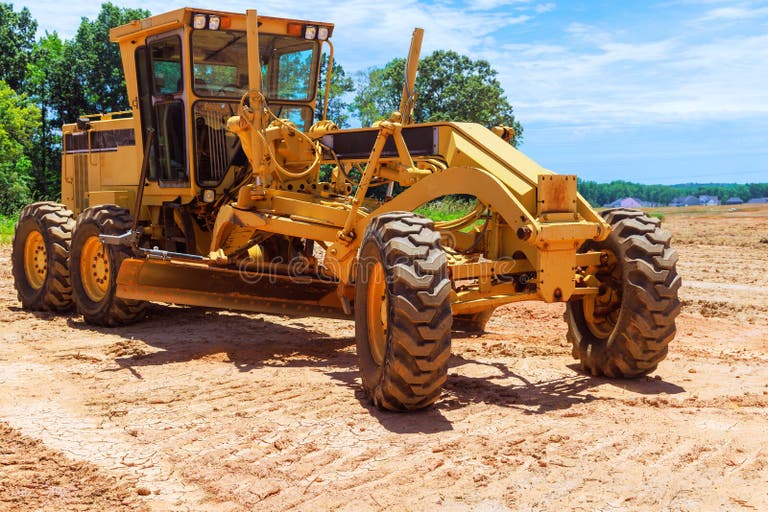 At Construction Site, a Heavy Earthmoving Construction Grader Tractor ...