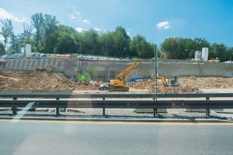 Construction Site with Heavy Machinery and Excavator on the Highway ...