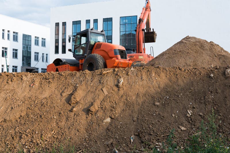 Construction Site. Lots of Dirt, an Excavator and a New White Building ...