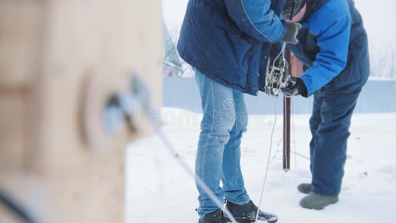 Construction Site. Man Workers Using the Tensioner for the Cargo Stock ...