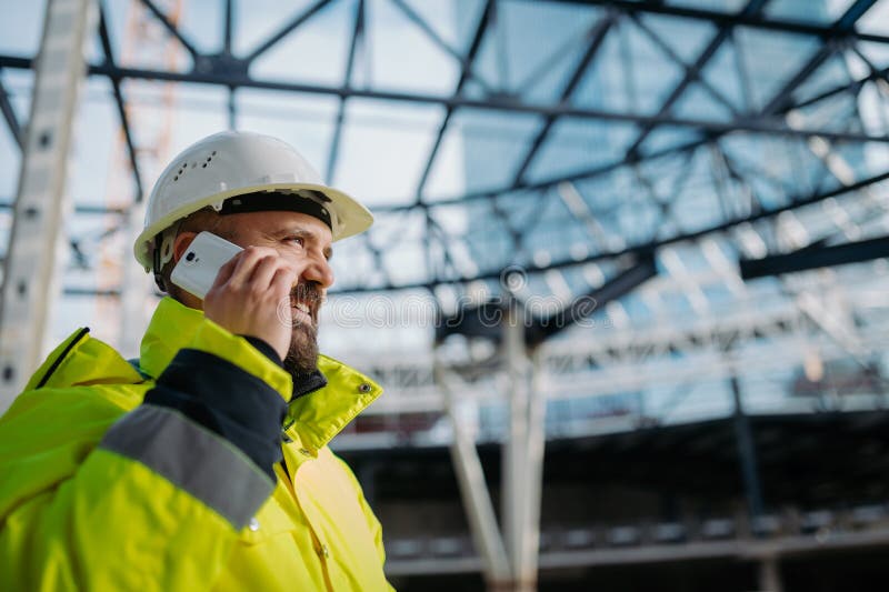 Construction Site Manager Making Phone Call while Inspecting Building ...