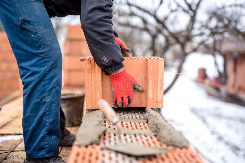 Construction Site and Mason Bricklayer Working with Bricks, Cement and ...