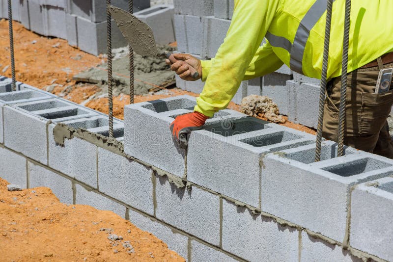 A Bricklayer, a Mason, is Laying the Mounting for a Wall of Concrete ...