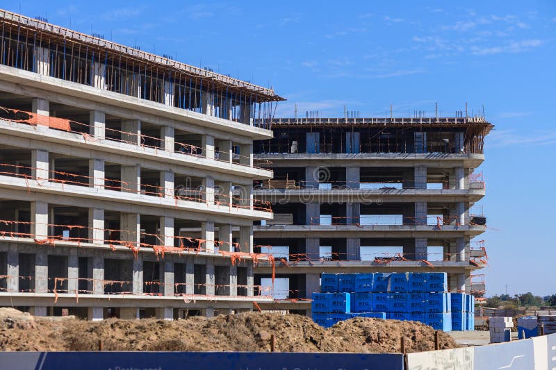 Construction Site of Modern Buildings Under Bright Blue Sky with Cranes ...