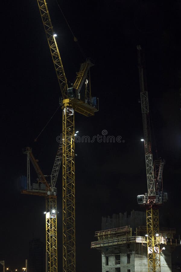 Construction Site with Cranes at Night Low Angle Vertical Stock Image ...