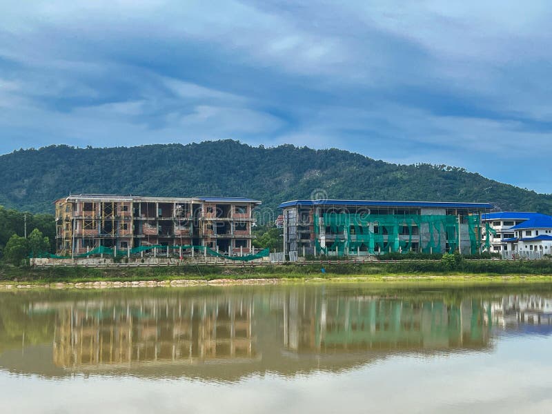 Construction Site with Partially Completed Buildings Reflected in a ...