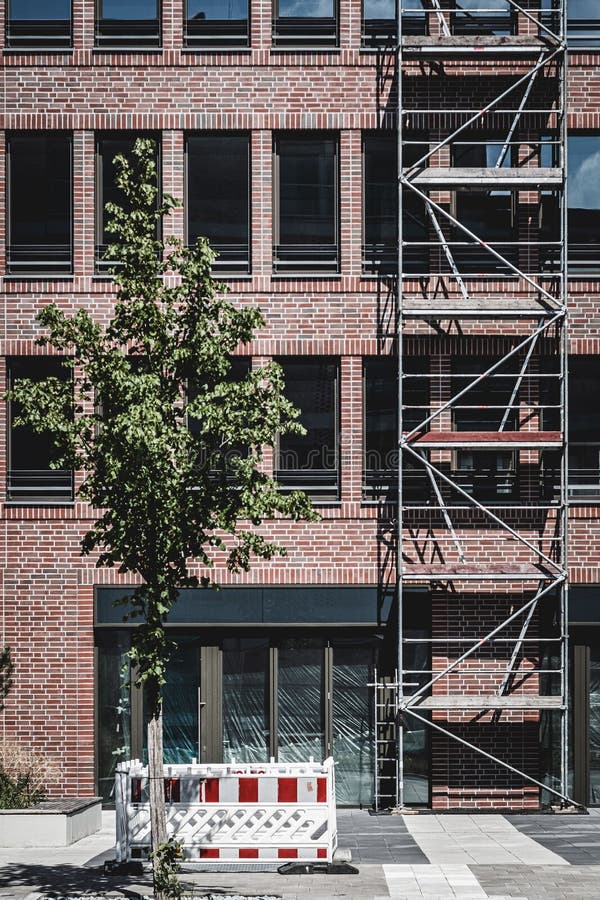 Construction Site with a Scaffold in Front of a Red Brick Wall Building ...