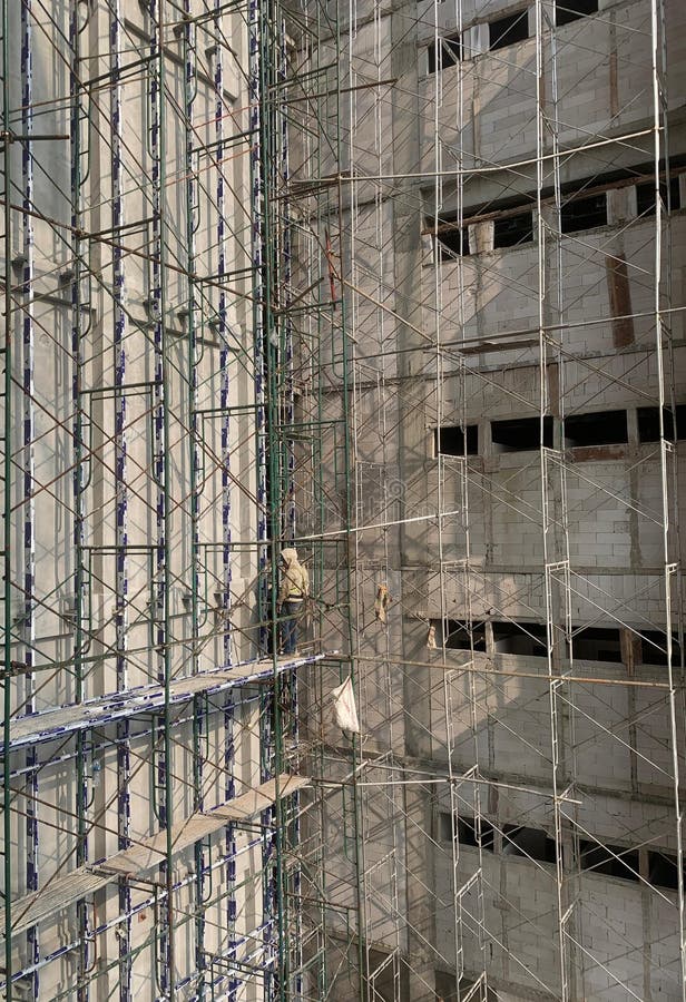 Photograph a Construction Site with Scaffolding Structures Surrounding ...