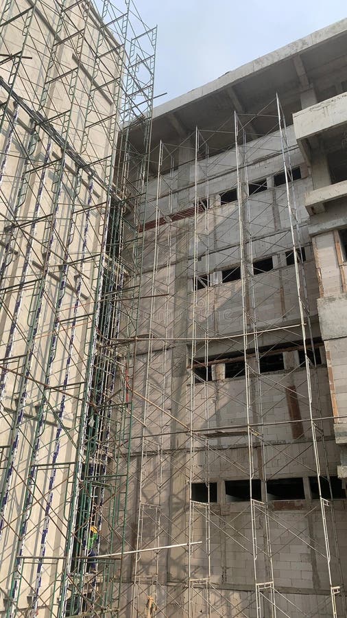 Photograph a Construction Site with Scaffolding Structures Surrounding ...