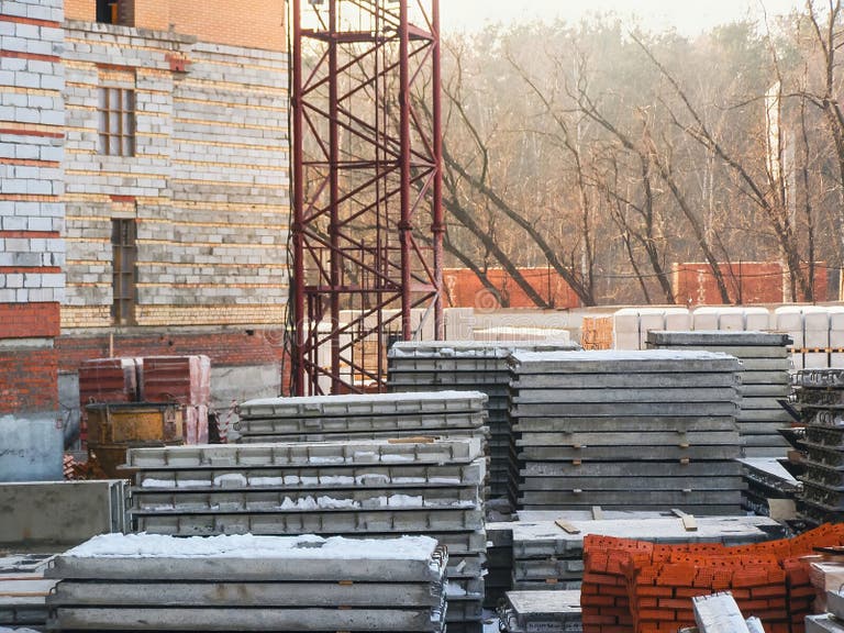 A Construction Site Scene Featuring Stacked Concrete Slabs, Bricks, and ...