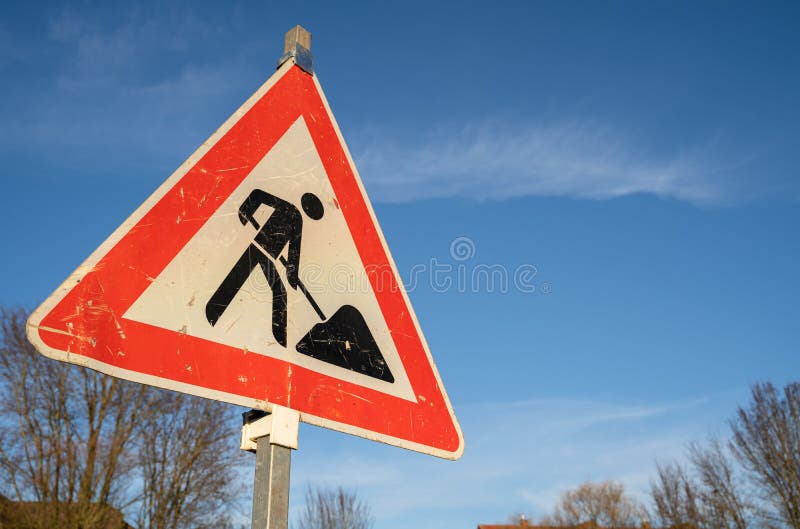 Construction Site Sign with a Blue Sunny Sky and Some Trees in the ...