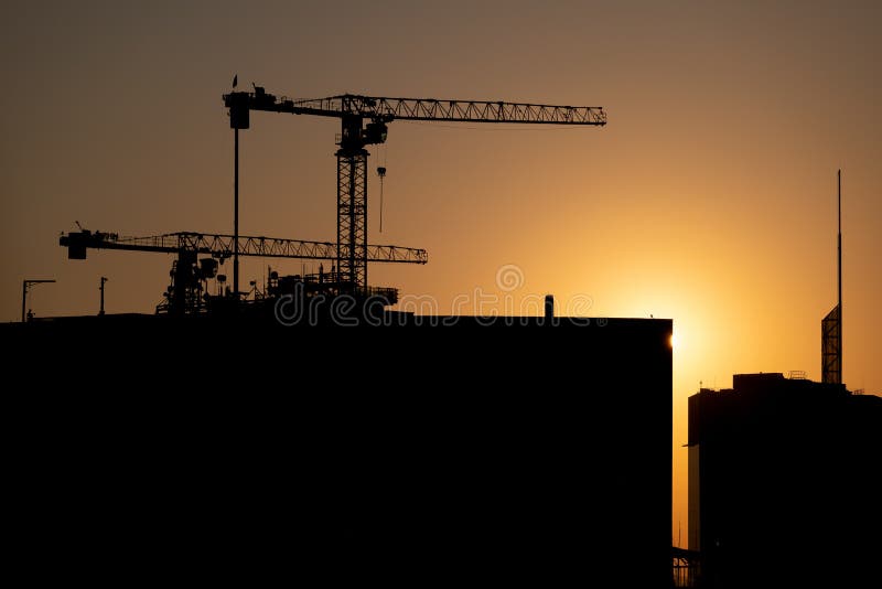 Construction Site Silhouette at Sunset Stock Photo - Image of cranes ...