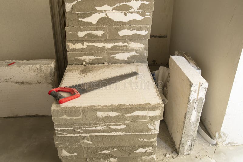 Construction Site with Stack of Gas Concrete Blocks and Mechanical Hand ...