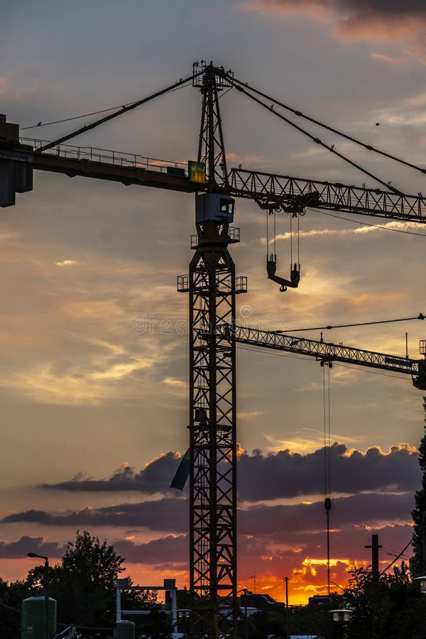 Construction Cranes at Sunset Stock Photo - Image of engineering ...