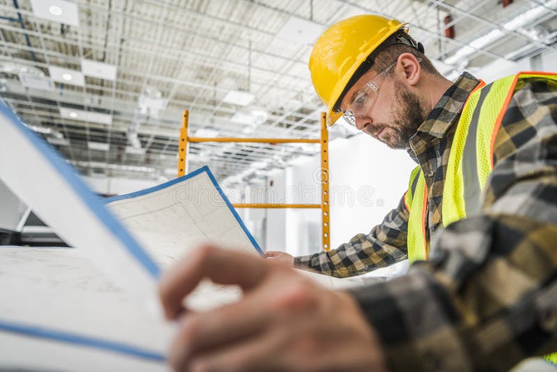 Construction Site Supervisor Taking Quick Look on a Blueprint Stock ...