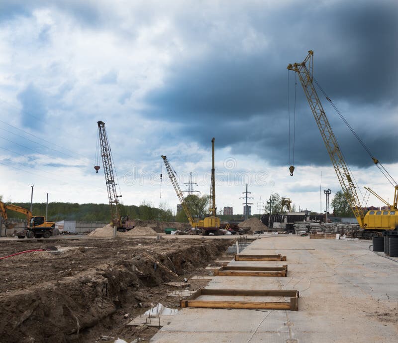 Construction Site with Tower Cranes. the Pit with Mounted Tires. Tower ...
