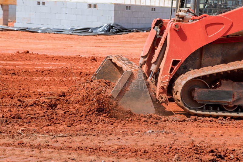 In a Construction Site, a Tractor Digger Scoop Moves and Aligns Itself ...