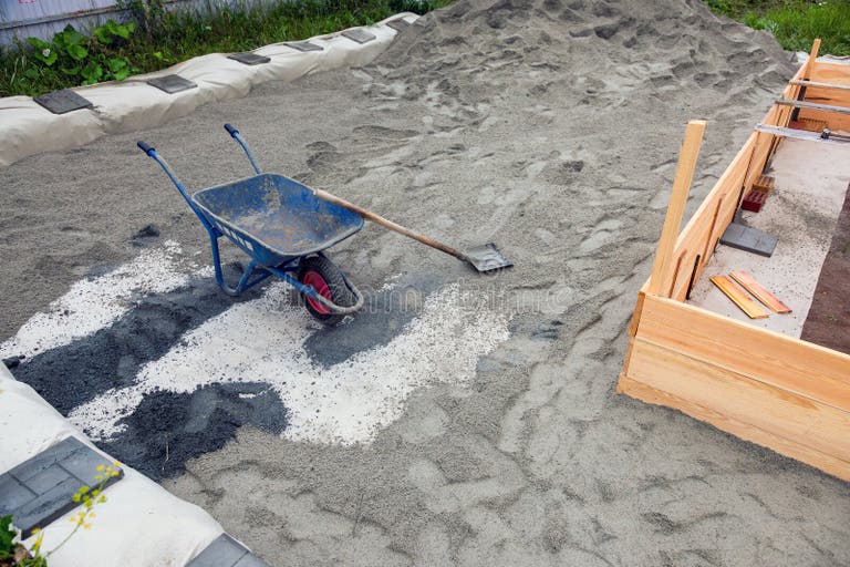 Construction Site with Wheelbarrow and Spade on Sand Stock Photo ...