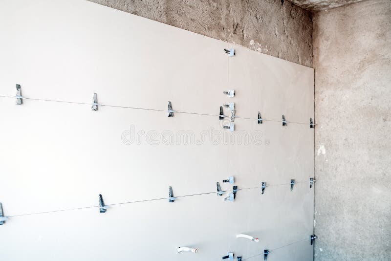 Construction Site. White Modern Tiles on Bathroom with Separator and ...