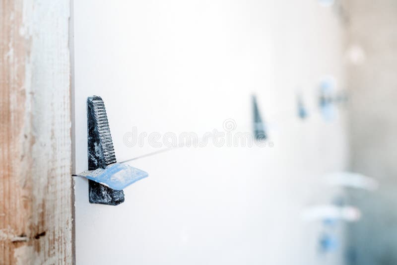 Construction Site. White Modern Tiles on Bathroom with Separator and ...