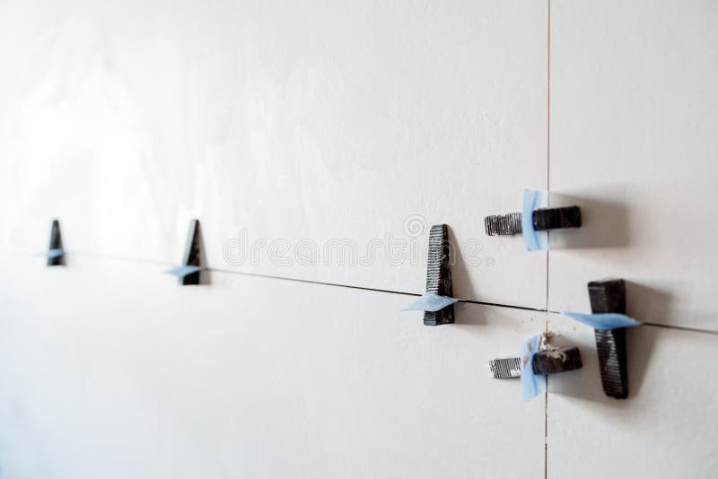 Construction Site. White Modern Tiles on Bathroom with Separator and ...