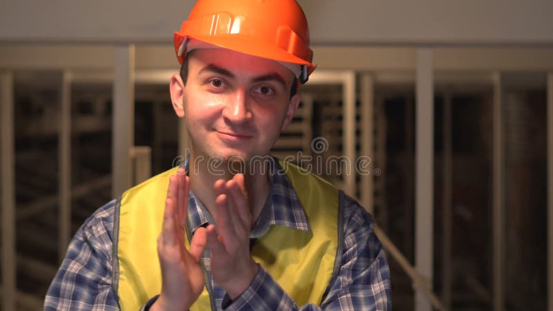 On a Construction Site, a Worker or Engineer or Architect is Looking at ...