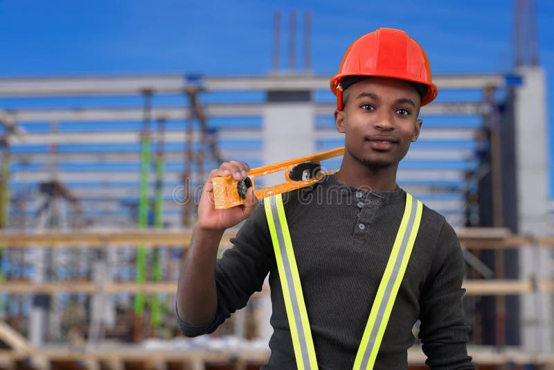 Construction Site Worker Holding Level Tool and Wearing Red Security ...
