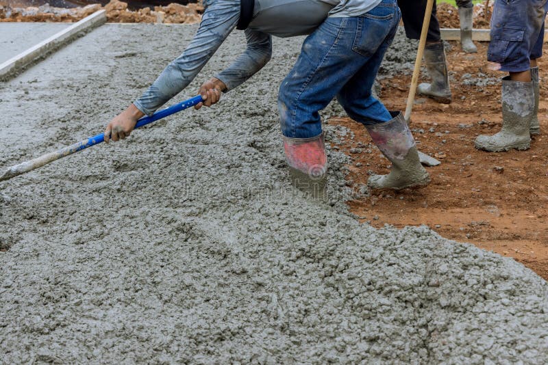 Construction Site Worker Pouring Wet Concrete while Paving a Driveway ...