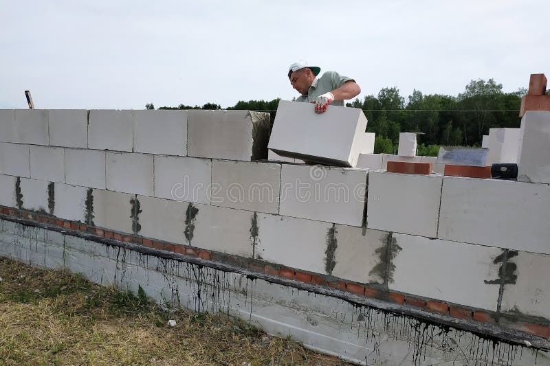 Auxiliary Worker Develops A Cement Mortar In A Concrete Mixer At The ...
