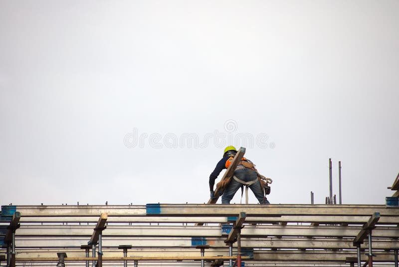 Man at Work Construction Site Worker Holding Beam on Roof Structure ...