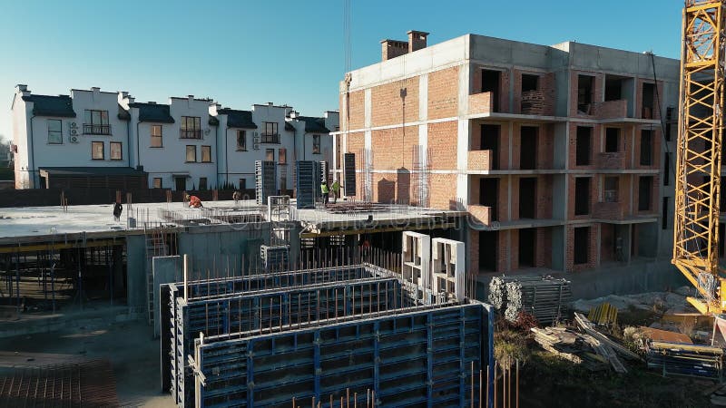 Construction Site with Workers, Crane, and Partially Built Multi-story ...